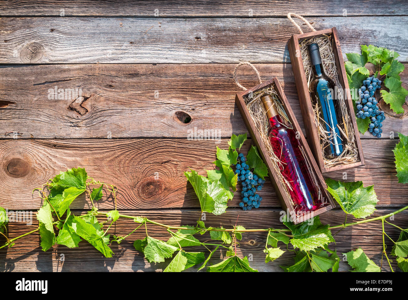 Different types of wine in a wooden box and grapes Stock Photo - Alamy