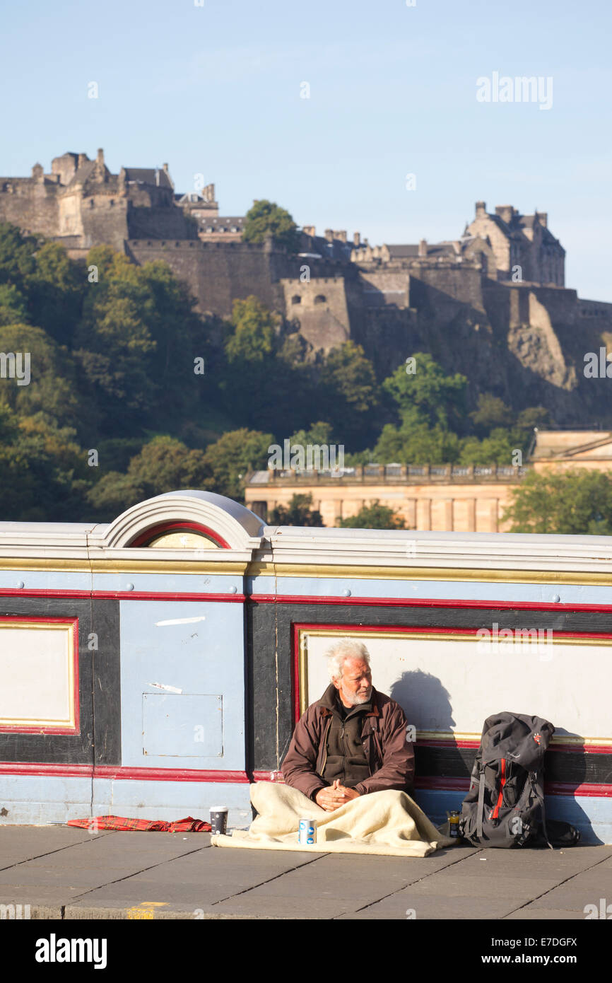 Homeless man begging on the North Bridge, with Edinburgh Castle in the ...