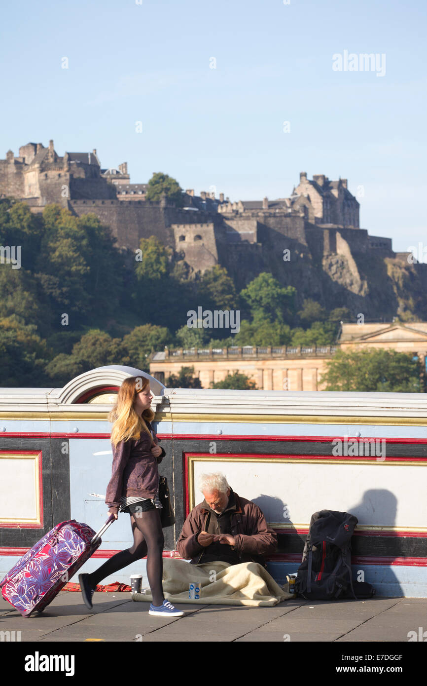 Homeless man begging on the North Bridge, with Edinburgh Castle in the ...