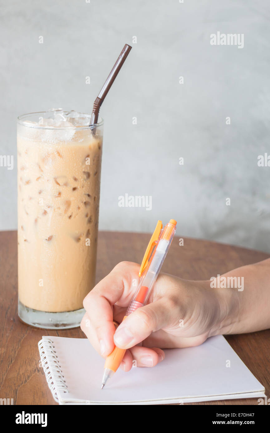 Hand writing on note paper in coffee shop, stock photo Stock Photo - Alamy