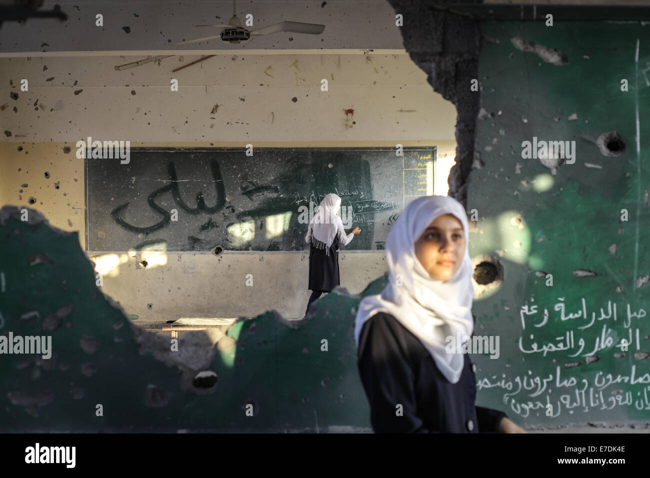 Palestinian students sit inside their school, on the second day of the ...
