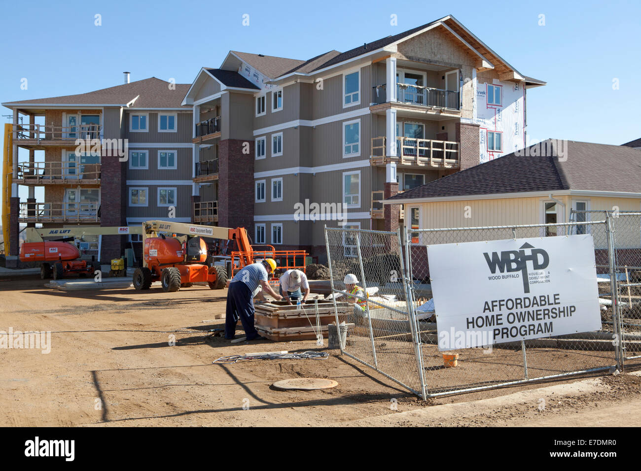 Construction worker on apartment construction site in new neighbourhood ...