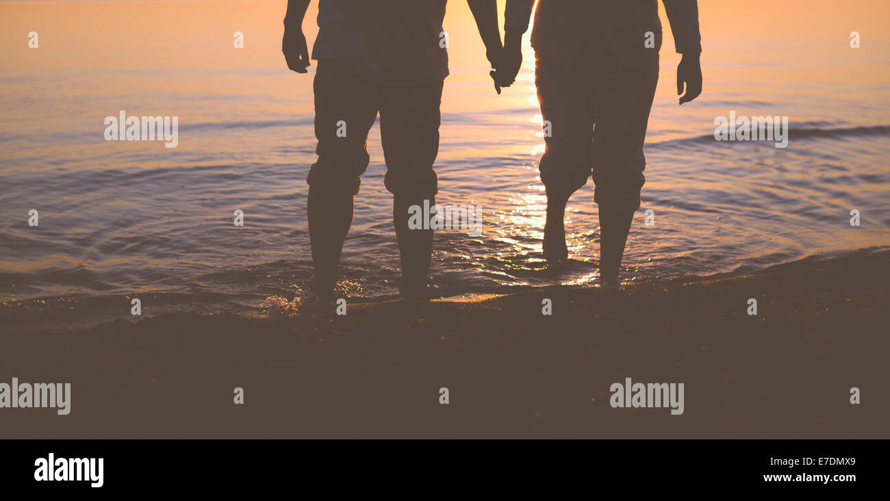 Senior couple walking at sunset Stock Photo - Alamy