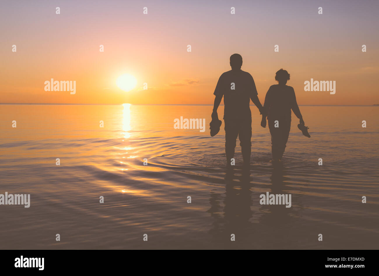 Old couple walking sunset hi-res stock photography and images - Alamy