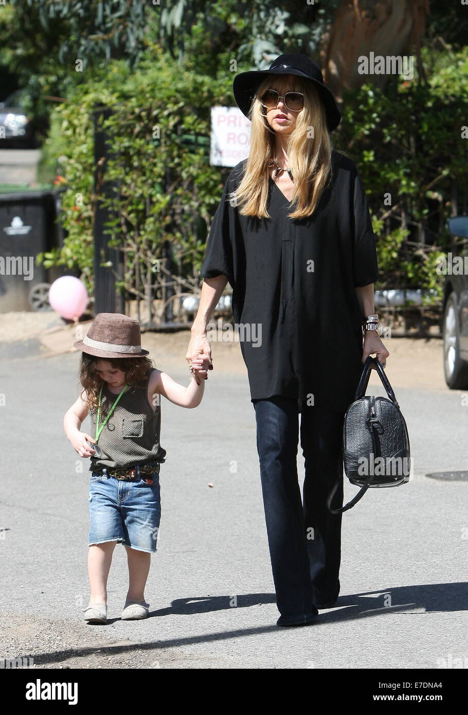 Rachel Zoe dressed all in black wearing a wide brimmed floppy hat and ...