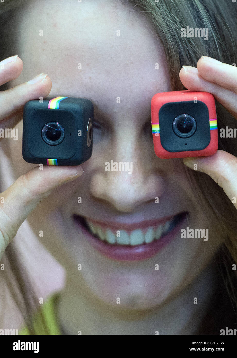 Cologne, Germany. 15th Sep, 2014. A model holds the new Polaroid Cube ...