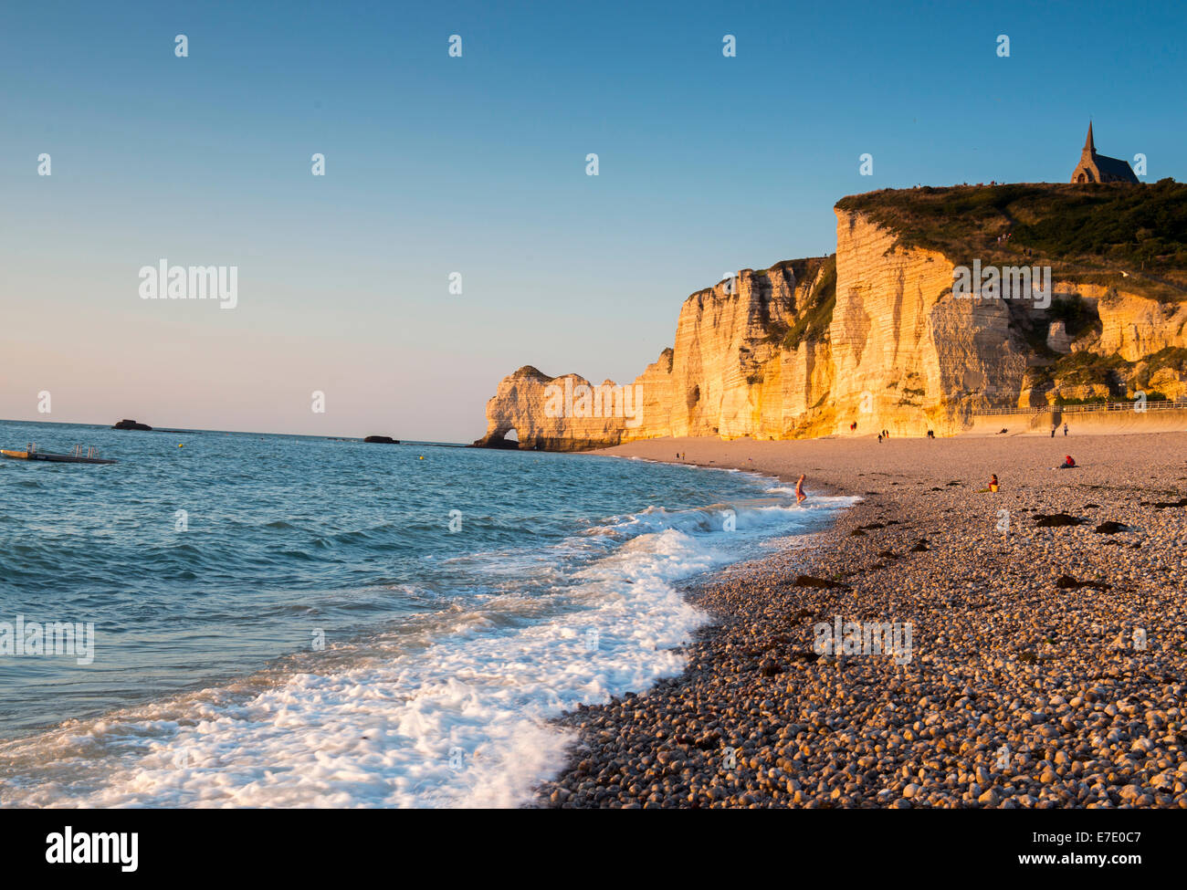 Sunset on the beach at Etratat on the coast of Normandy in Northern ...