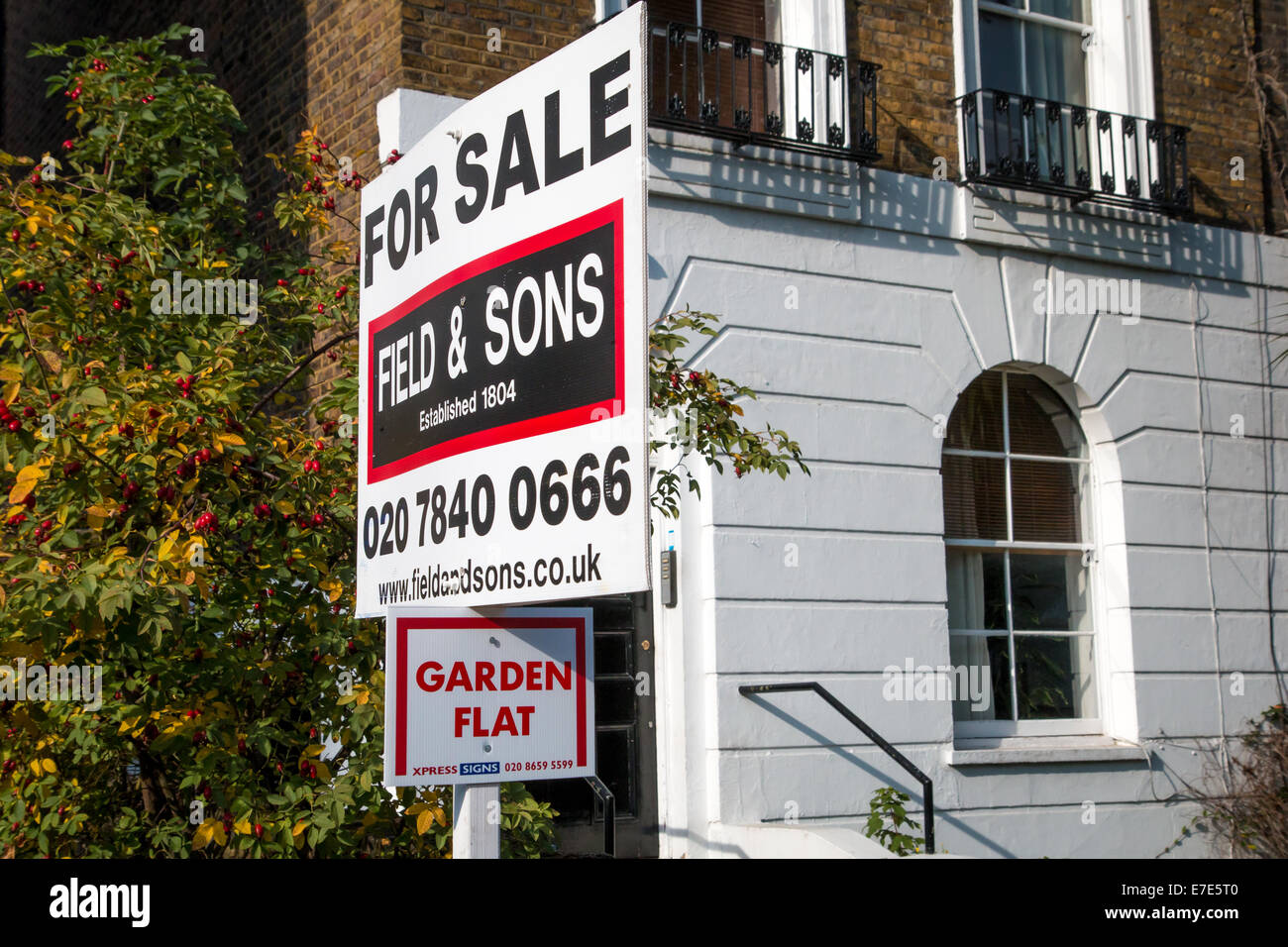 sale sign outside a house, garden flat Stock Photo - Alamy