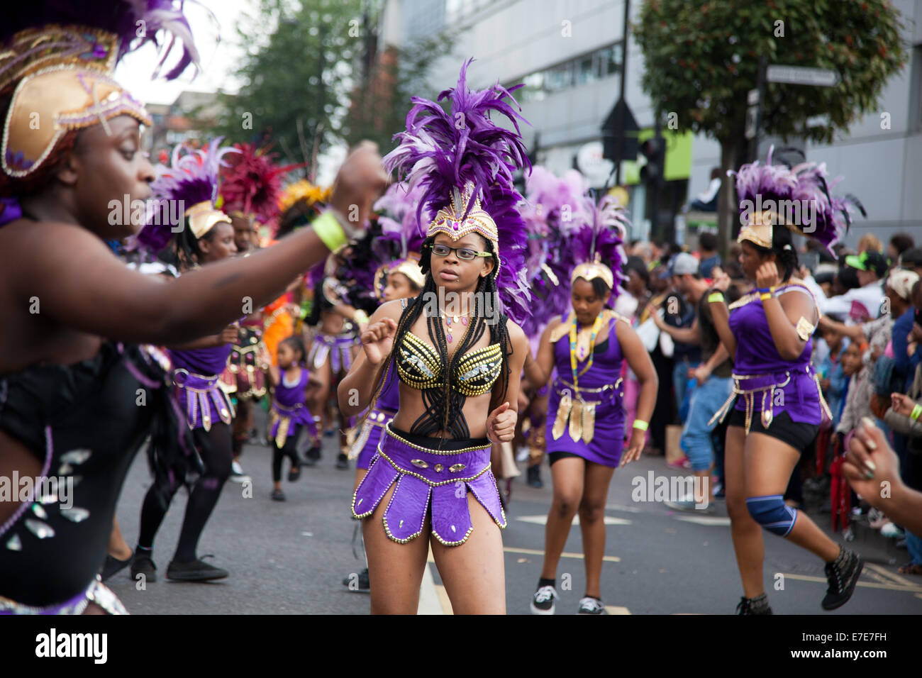 Women dancers dressed in purple make their way past Hackney Town Hall ...