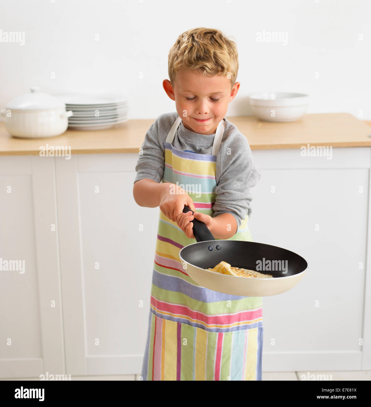 Boy flipping pancake in frying pan Stock Photo - Alamy