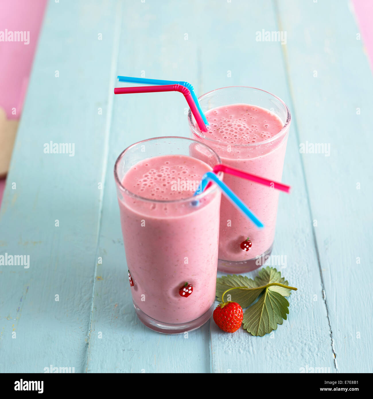 Strawberry smoothies with straws Stock Photo - Alamy