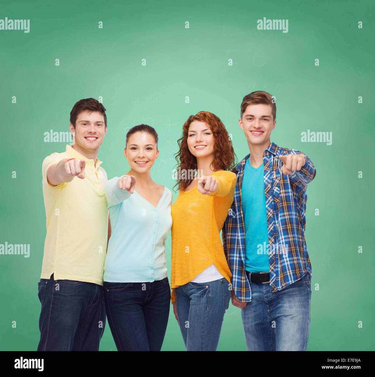 group of smiling teenagers over green board Stock Photo - Alamy