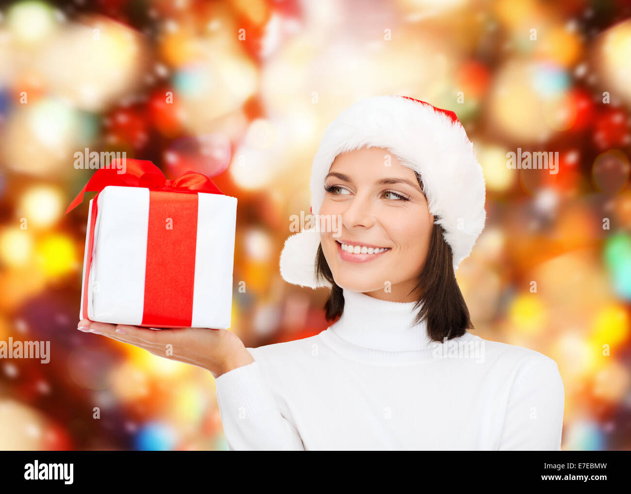 smiling woman in santa helper hat with gift box Stock Photo - Alamy