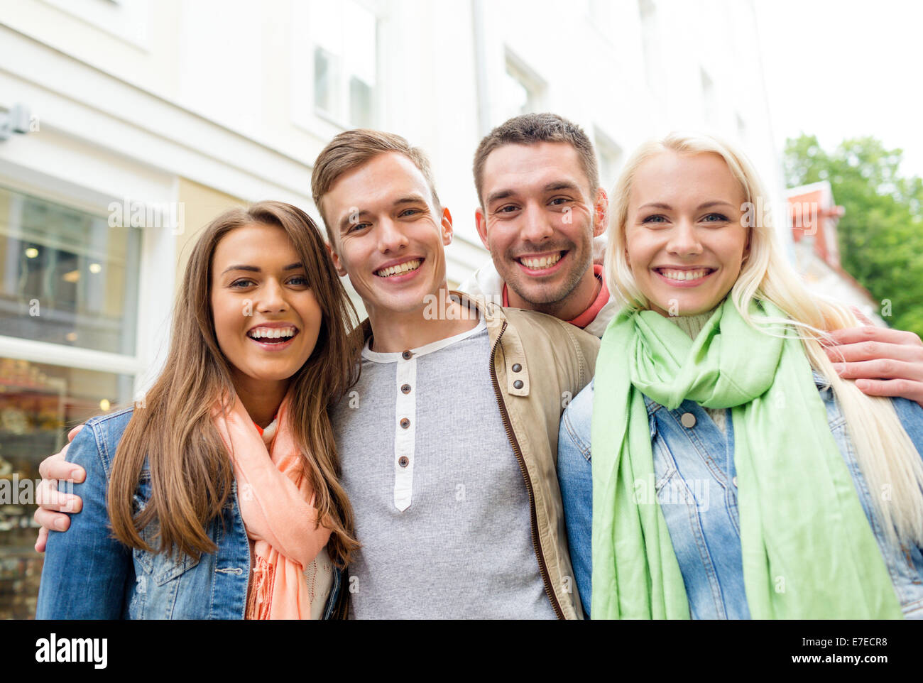group of smiling friends in city Stock Photo - Alamy