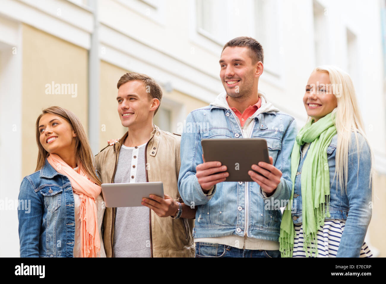 group of smiling friends with tablet pc computers Stock Photo - Alamy