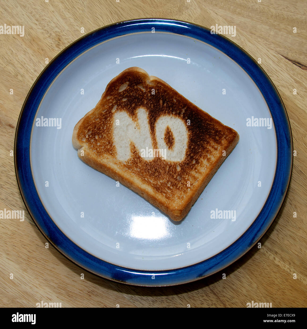 NO burnt onto a piece of toast Stock Photo - Alamy