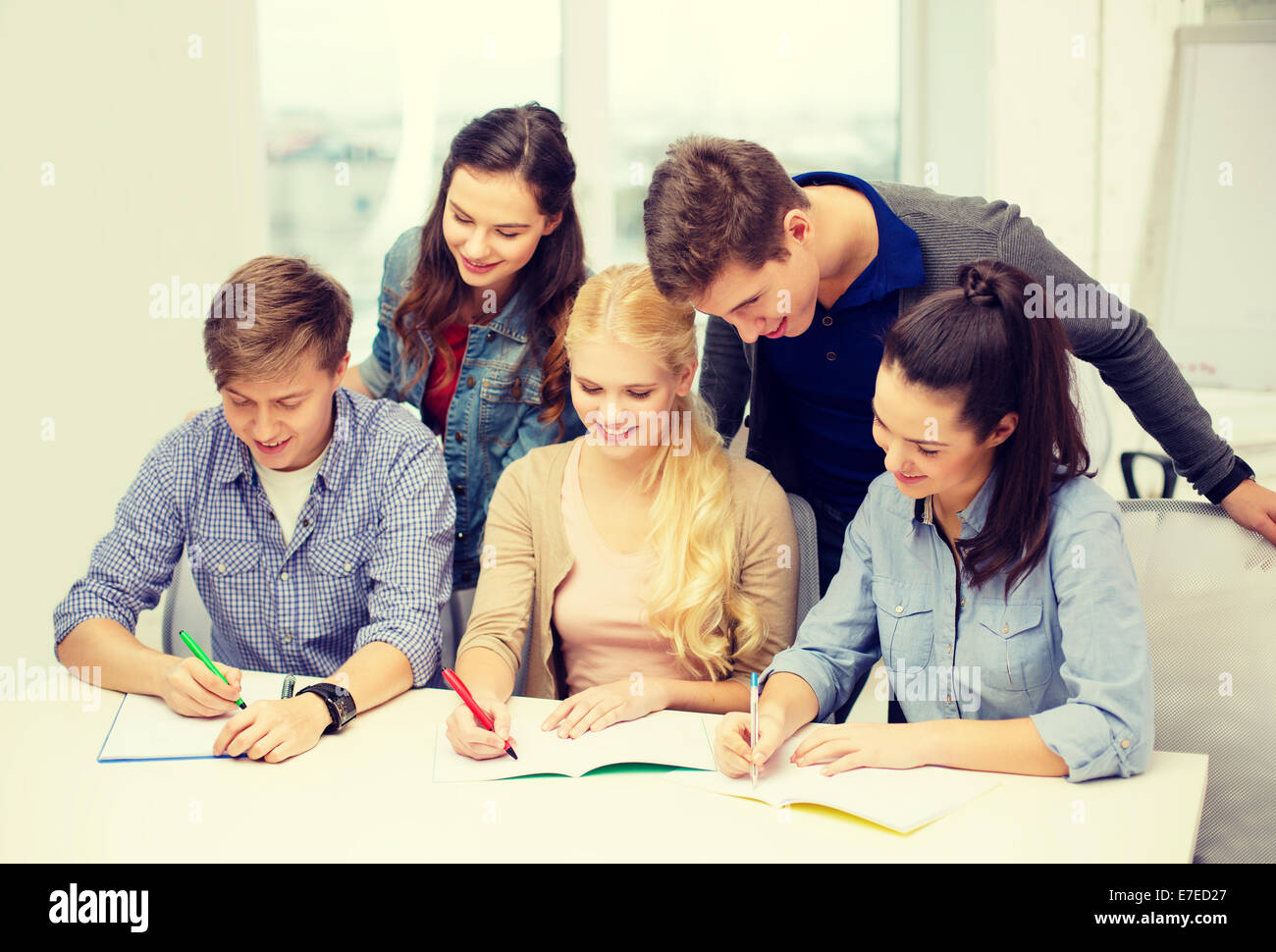 smiling students with notebooks at school Stock Photo - Alamy