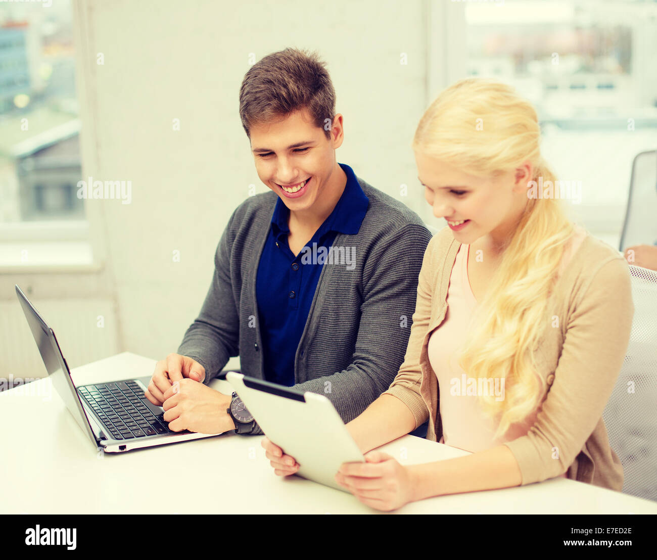 two teens with laptop and tablet pc at school Stock Photo - Alamy