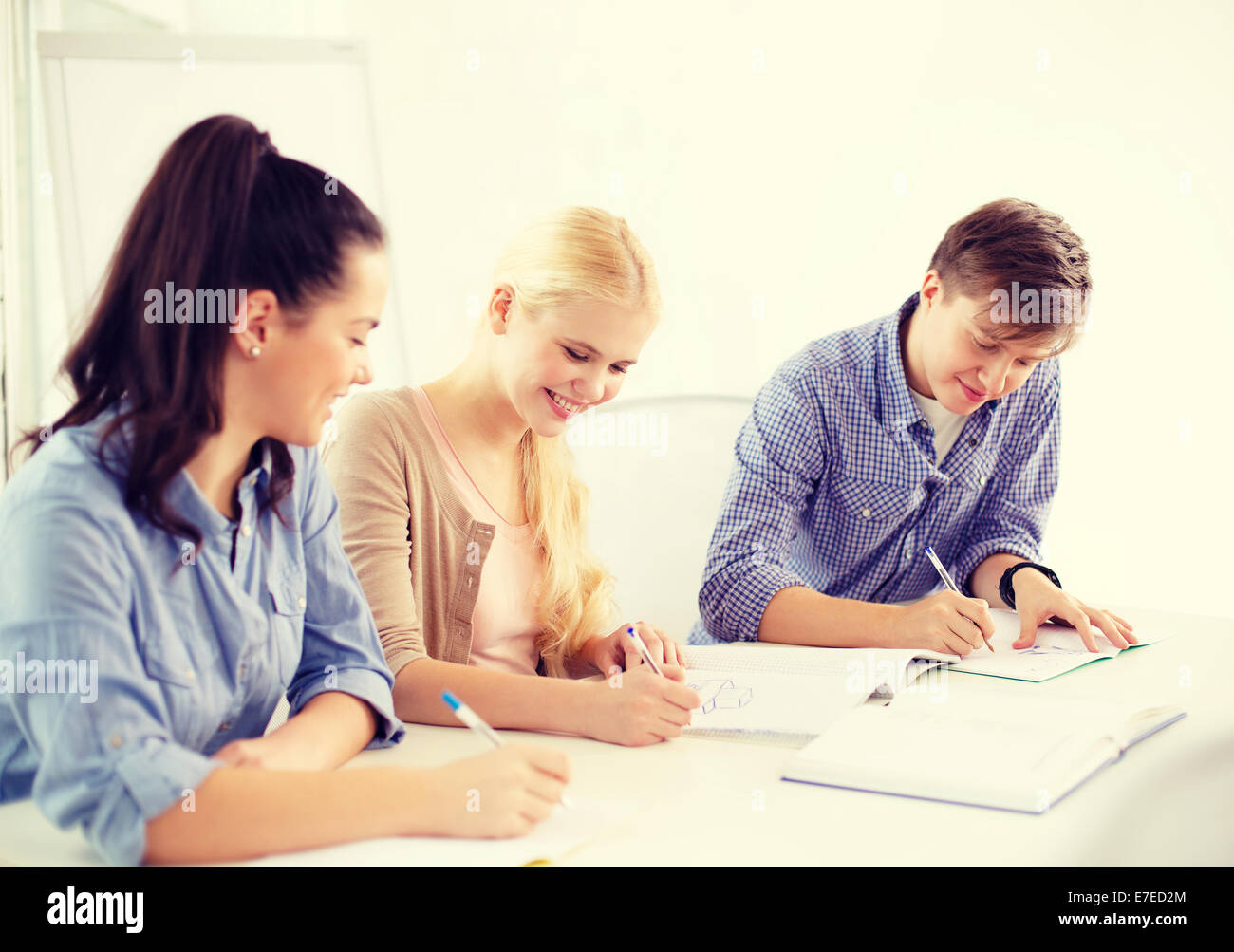 smiling students with notebooks at school Stock Photo - Alamy