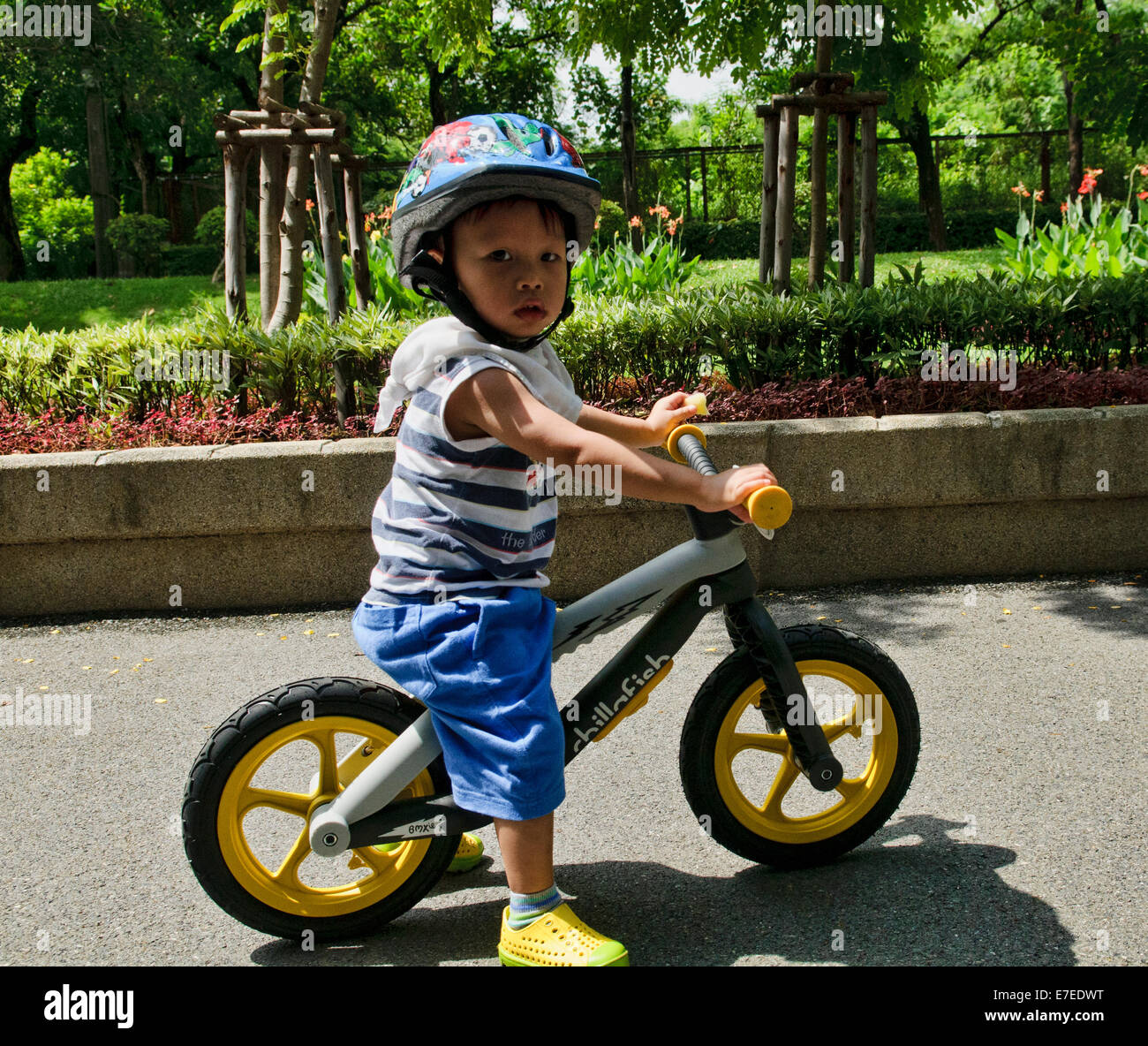 Kid cycling on a public park in Bangkok, Thailand Stock Photo - Alamy