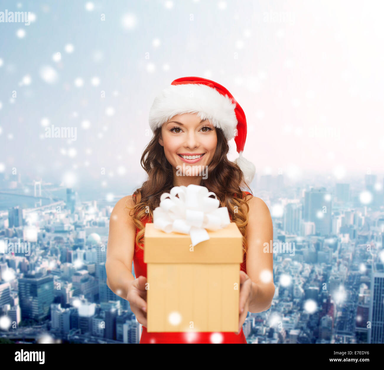 smiling woman in santa helper hat with gift box Stock Photo - Alamy