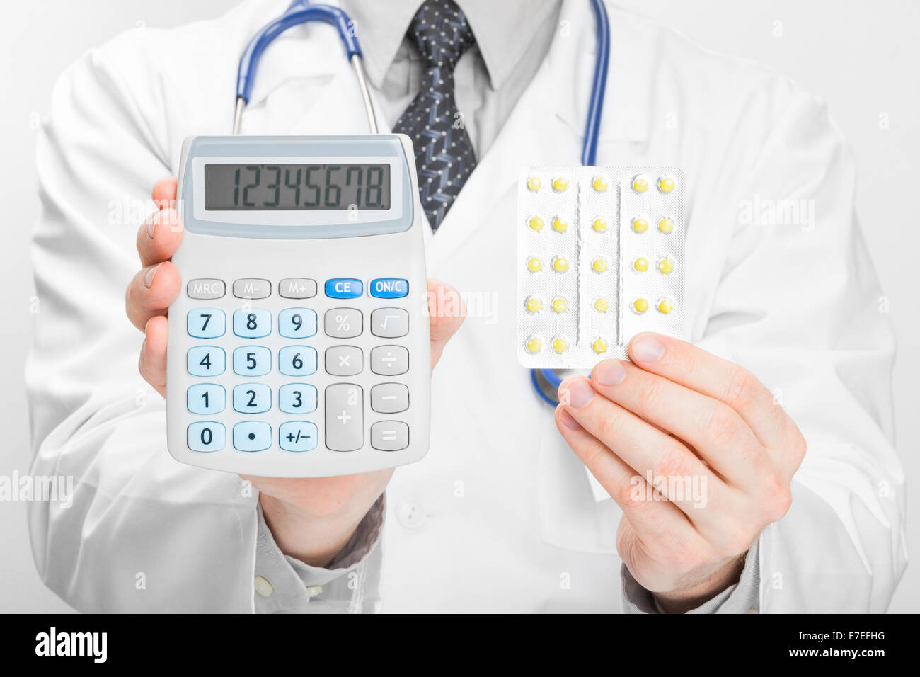 Doctor holdling calculator and pills in his hands - heath care concept ...