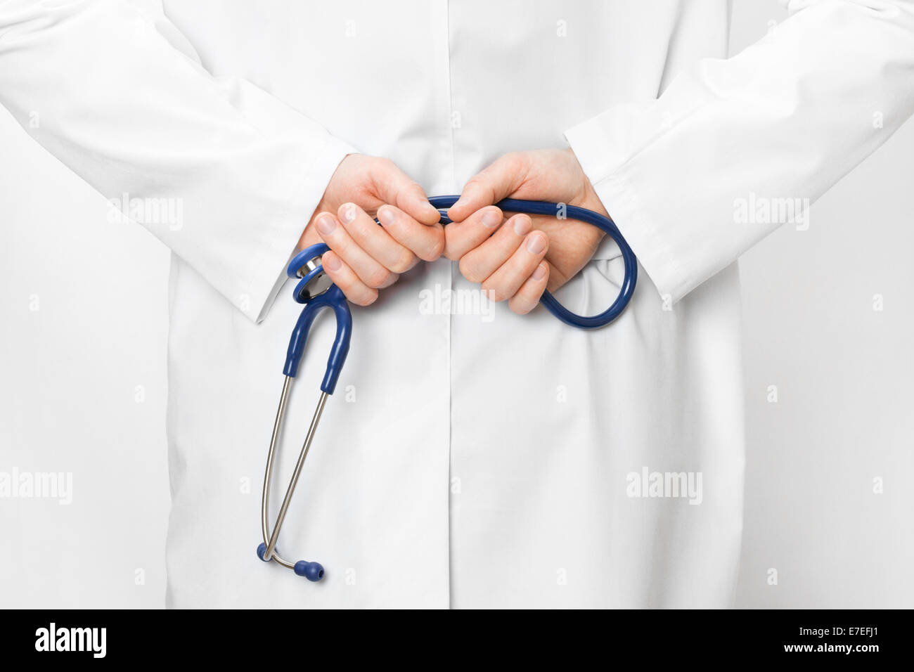 Doctor holding stethoscope behind his back Stock Photo - Alamy