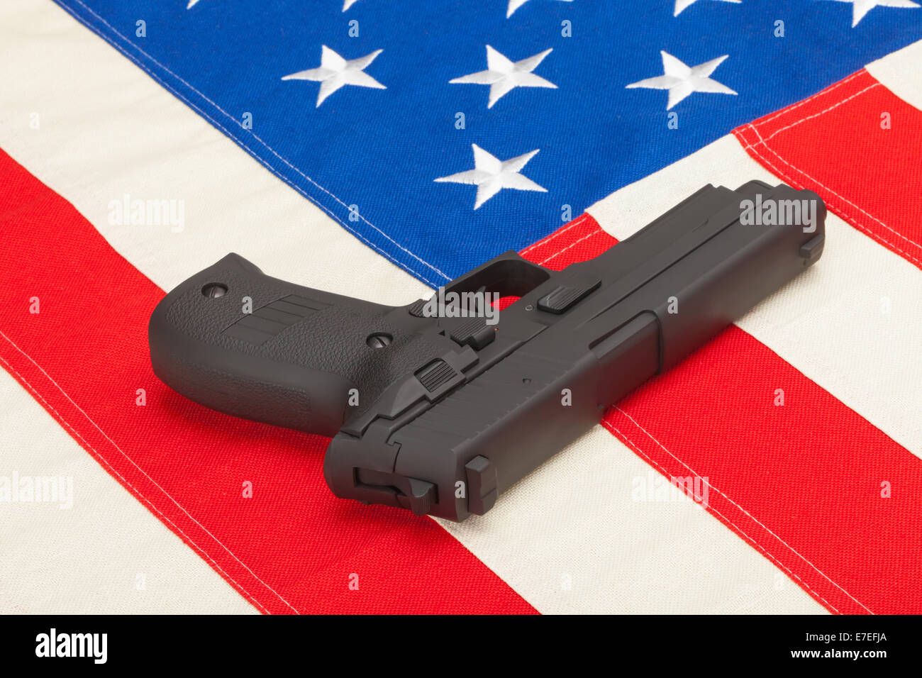Handgun laying over USA flag - studio shoot Stock Photo - Alamy