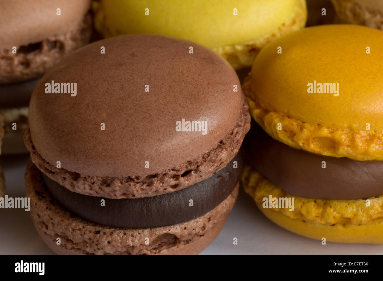 A close up photograph of some colorful macaroons. A macaroon is a ...