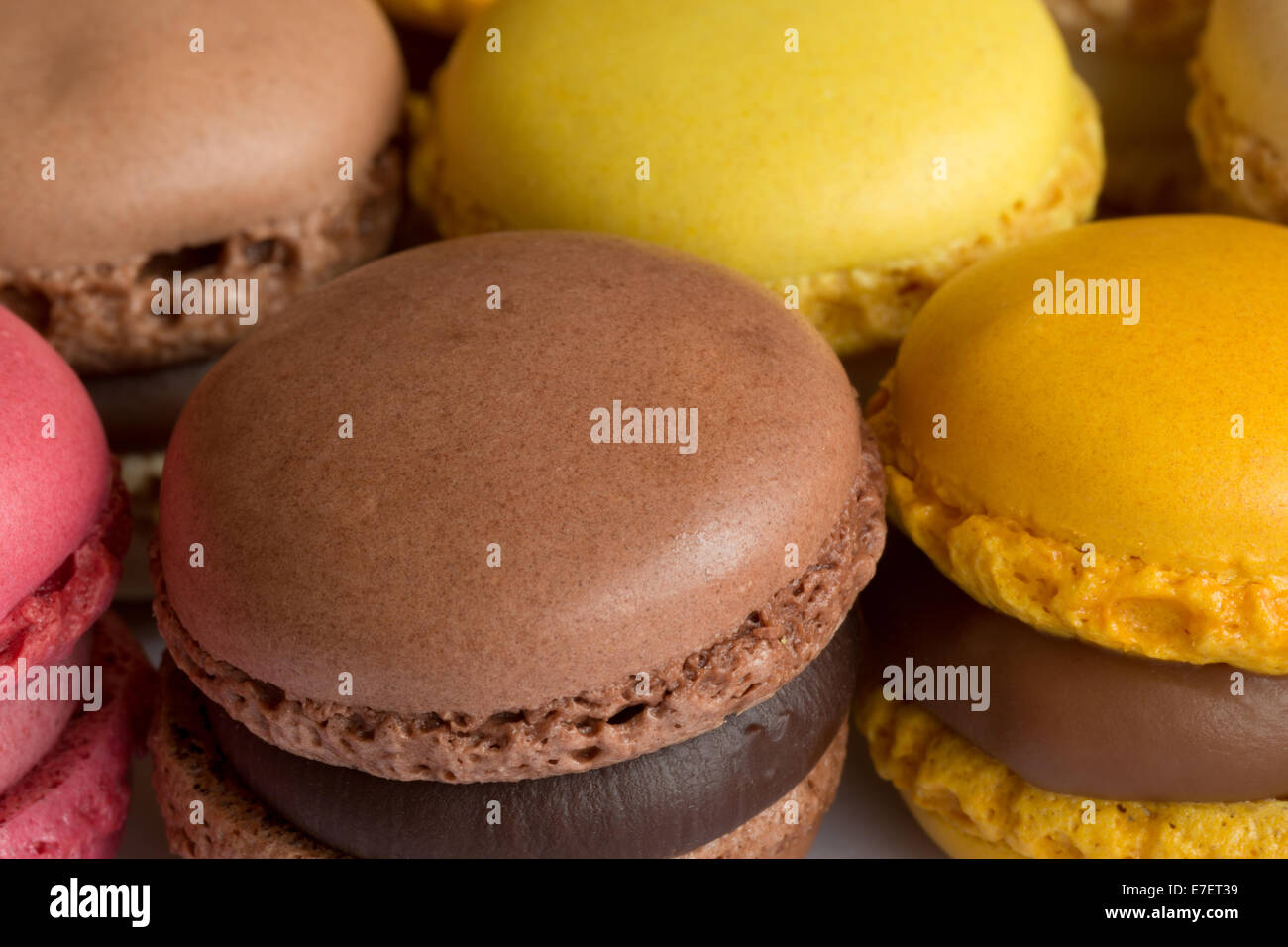 A close up photograph of some colorful macaroons. A macaroon is a ...