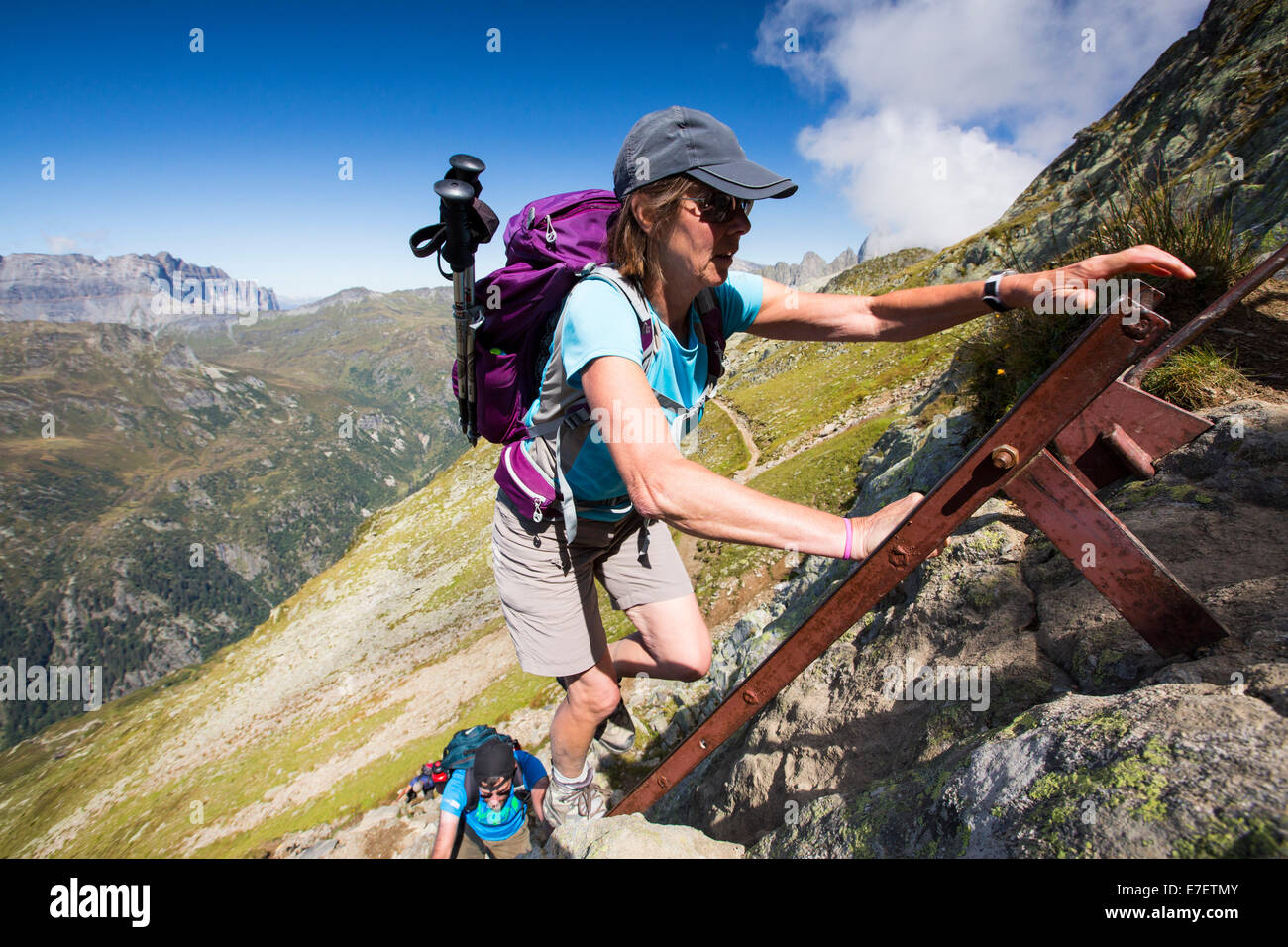 Walkers ascending ladders on the Aiguille Rouge above Chamonix, France ...