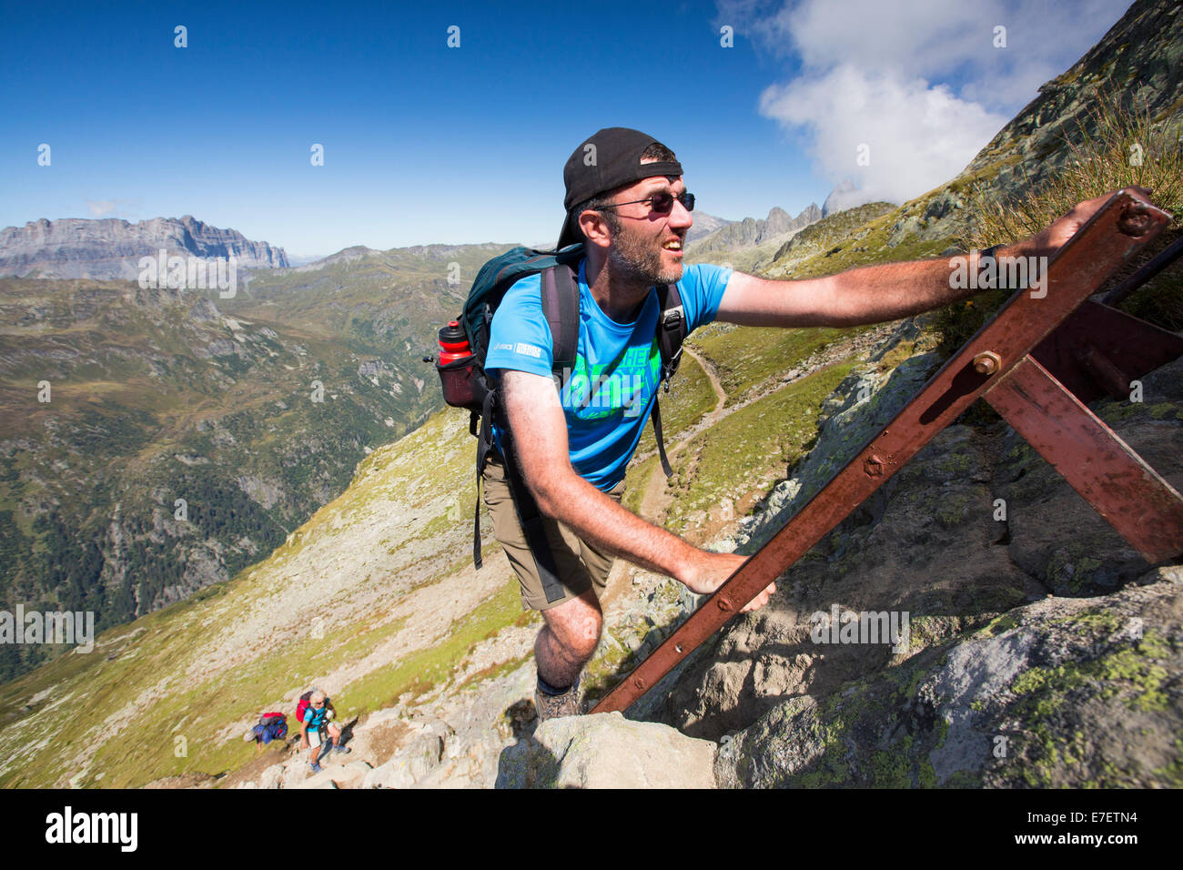 Walkers ascending ladders on the Aiguille Rouge above Chamonix, France ...