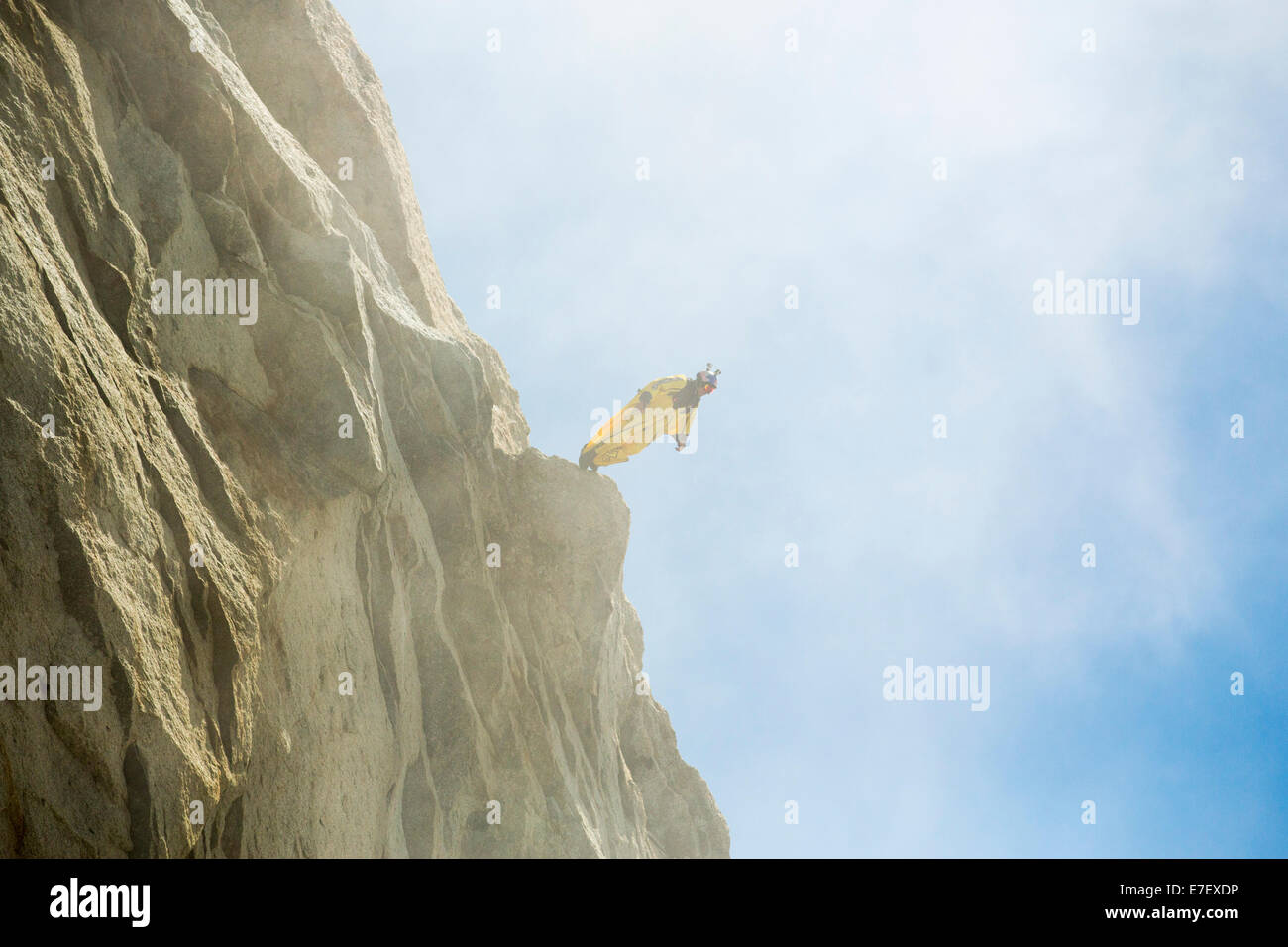 A base jumper wearing a wing suite jumps from the Aiguille Du Midi ...