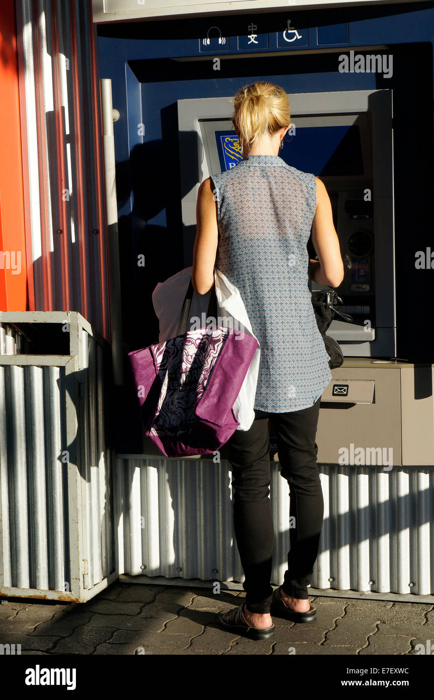 Woman using an outdoor automated banking machine or ATM, Vancouver, BC ...