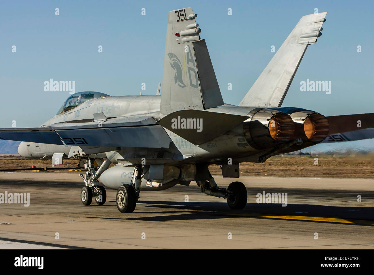 A U.S. Navy F/A-18C Hornet lights the afterburners as it begins its ...