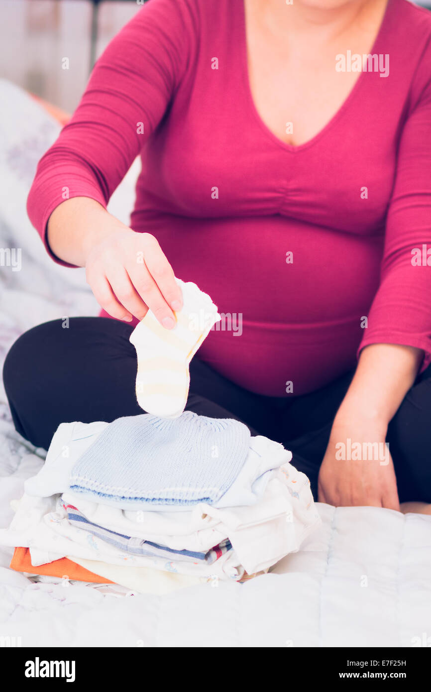 Pregnant woman packing hospital bag preparing for labor Stock Photo - Alamy