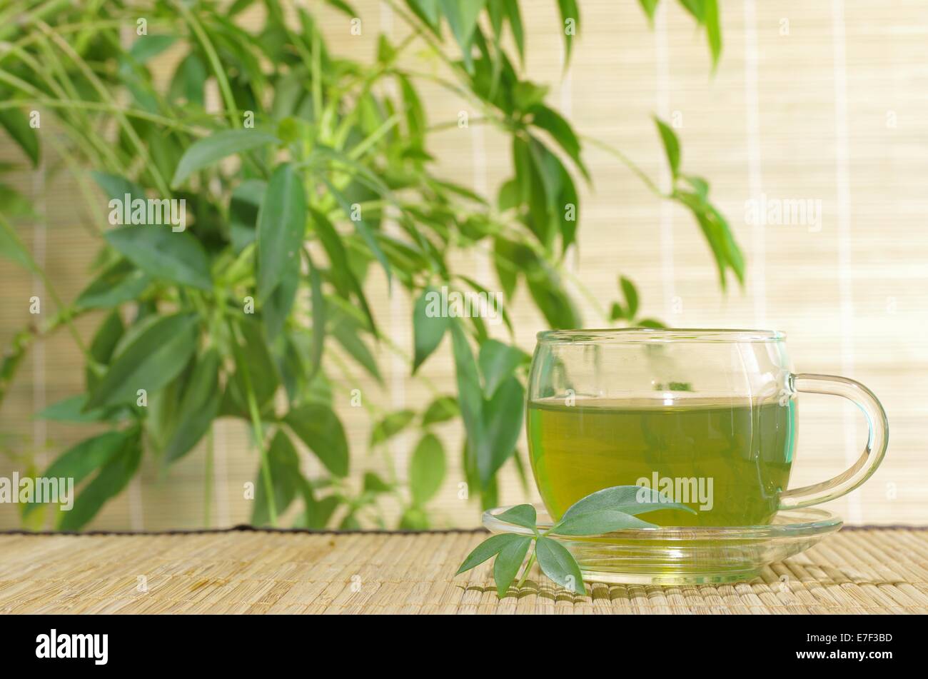 green tea in cup on plants' background Stock Photo - Alamy