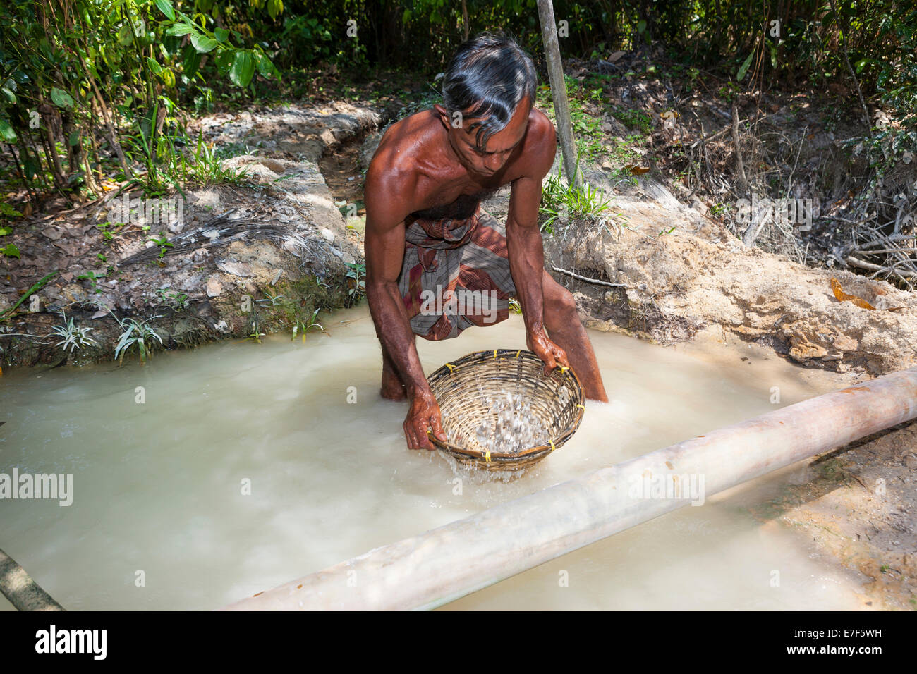 A labourer washing sand to win moonstones, Moonstone Mine, Nindana ...
