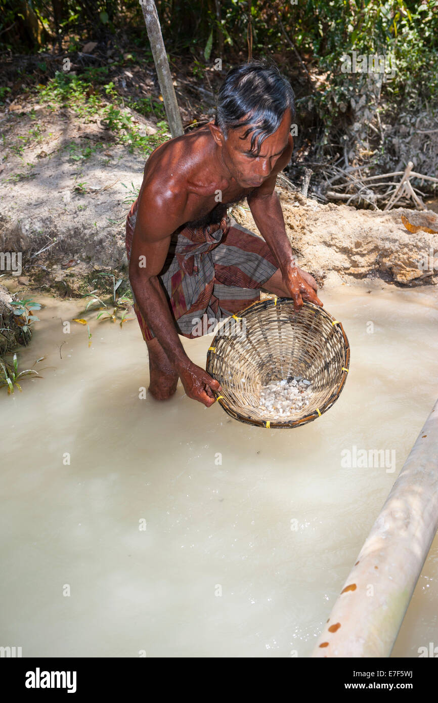A labourer washing sand to win moonstones, Moonstone Mine, Nindana ...