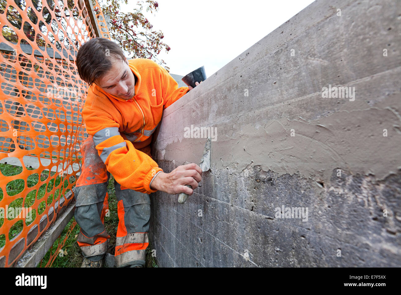 Man doing concrete restoration and construction work on the main ...