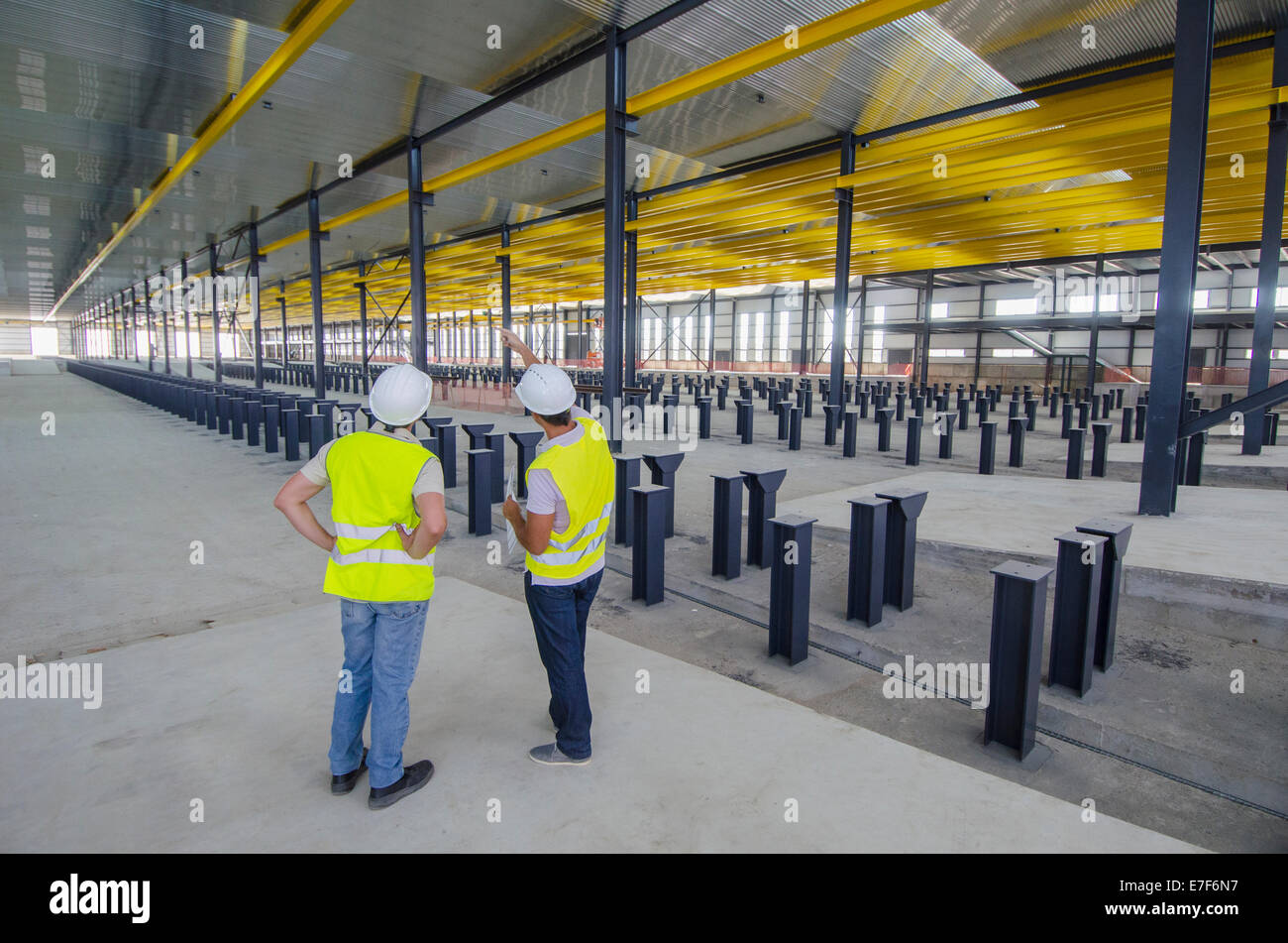 Workers examining warehouse Stock Photo - Alamy