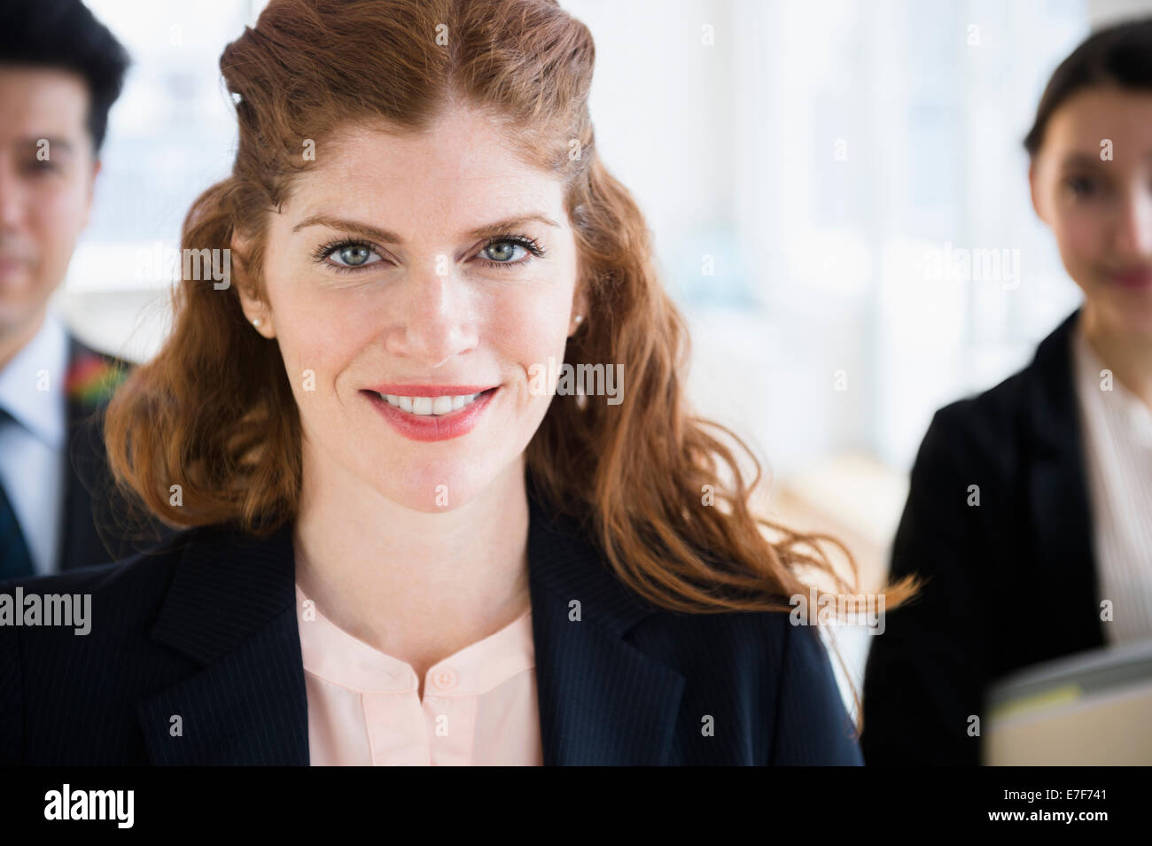 Business people smiling in office Stock Photo - Alamy