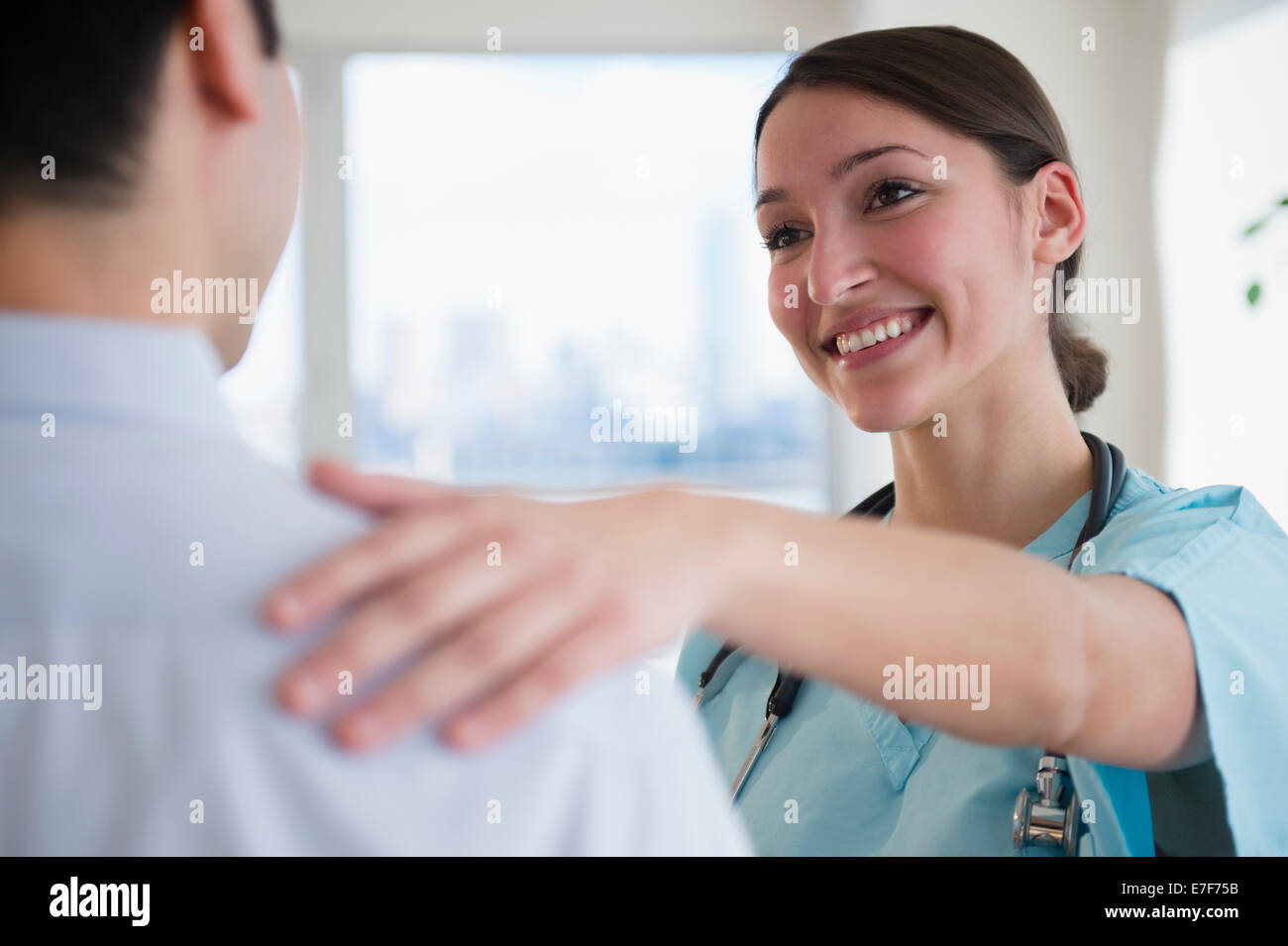 Doctor and nurse hugging in office Stock Photo - Alamy