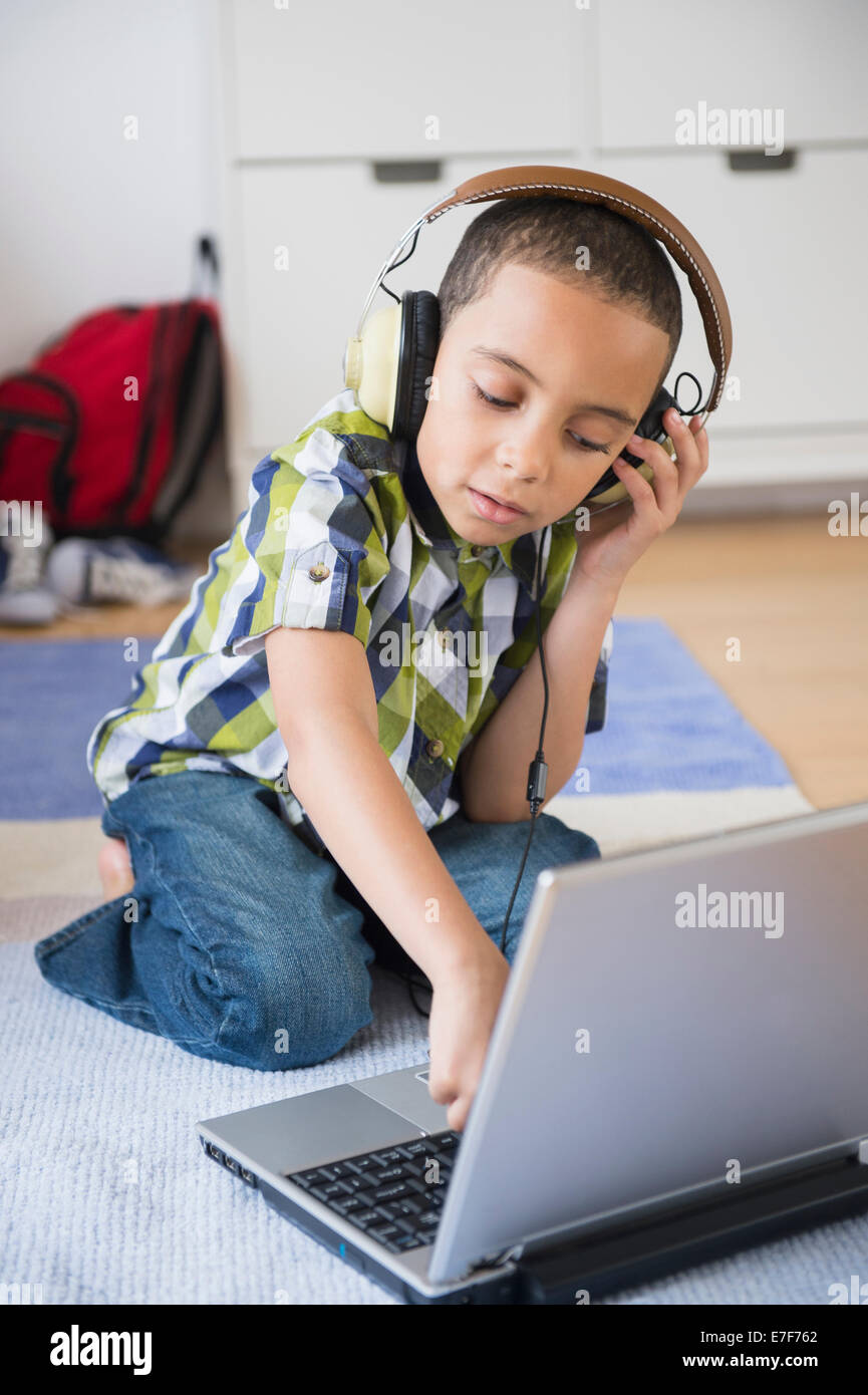 Boy listening with headphones hi-res stock photography and images - Alamy