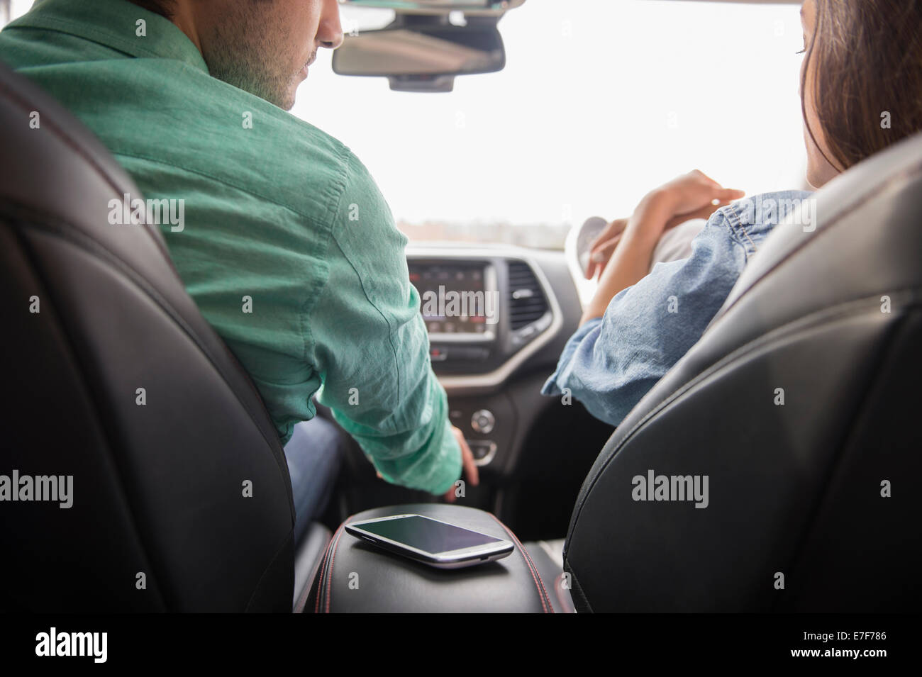 Couple with cell phone in car Stock Photo - Alamy