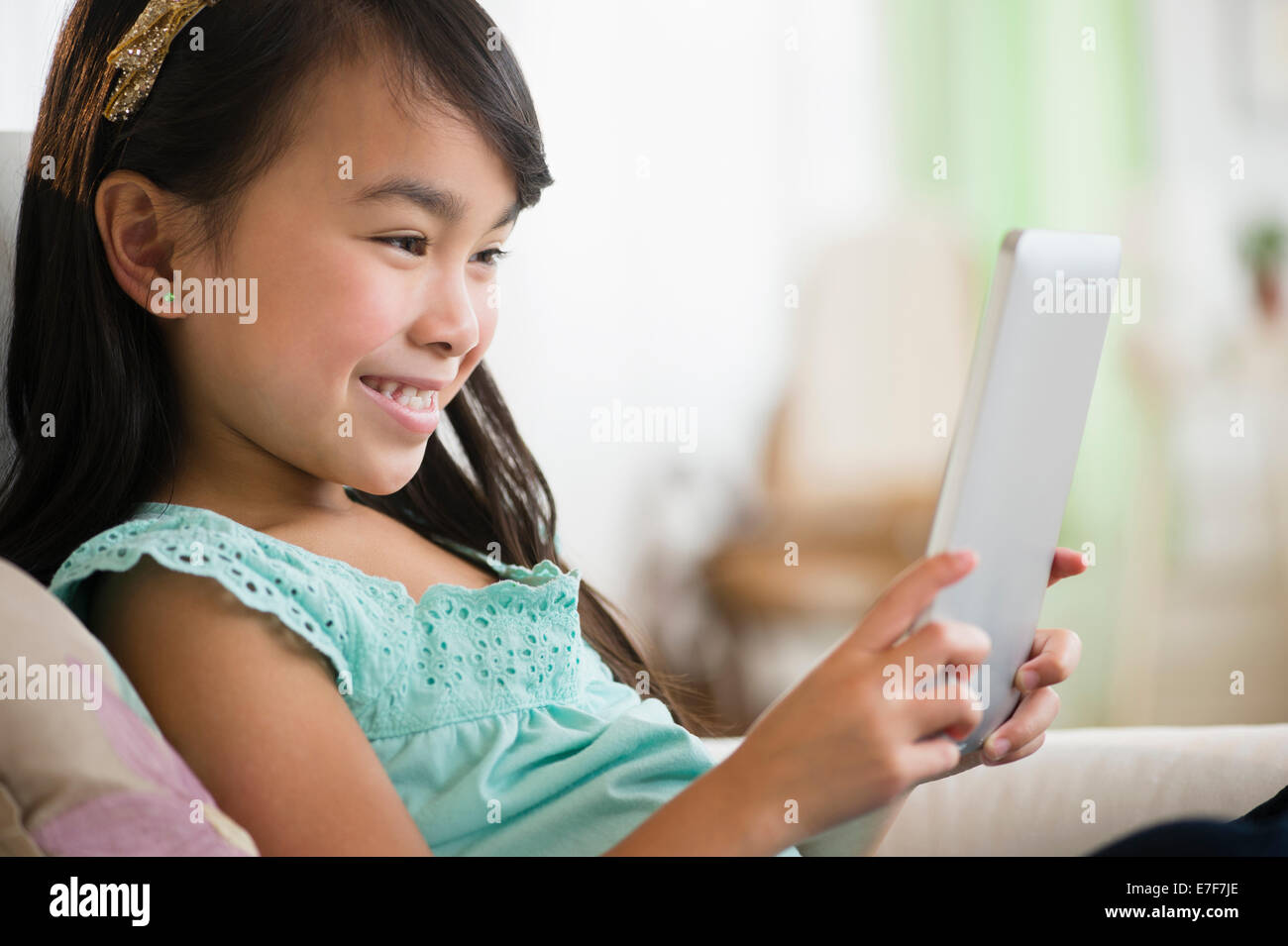 Filipino girl using tablet computer Stock Photo - Alamy