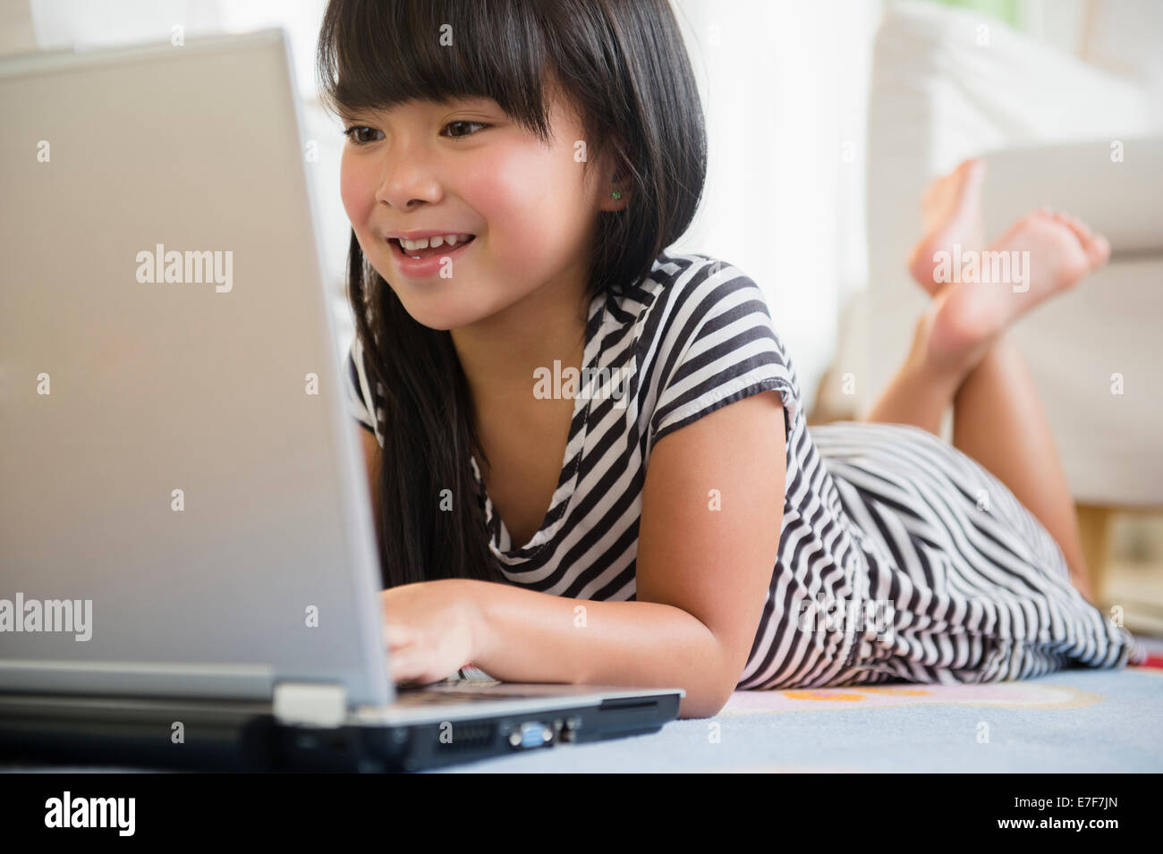 Filipino girl using laptop on floor Stock Photo - Alamy