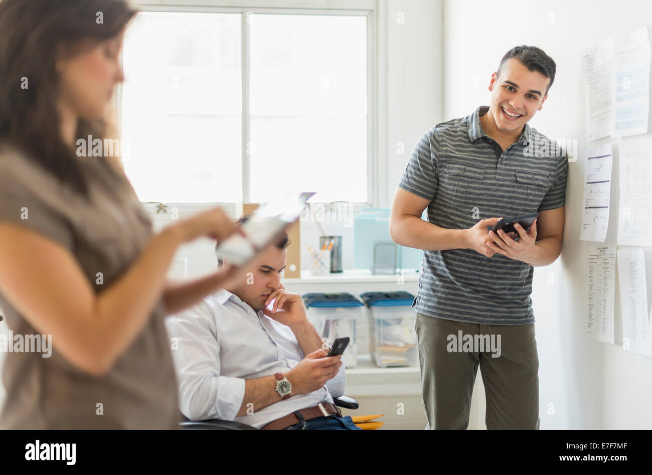 Hispanic business people using technology in office Stock Photo - Alamy