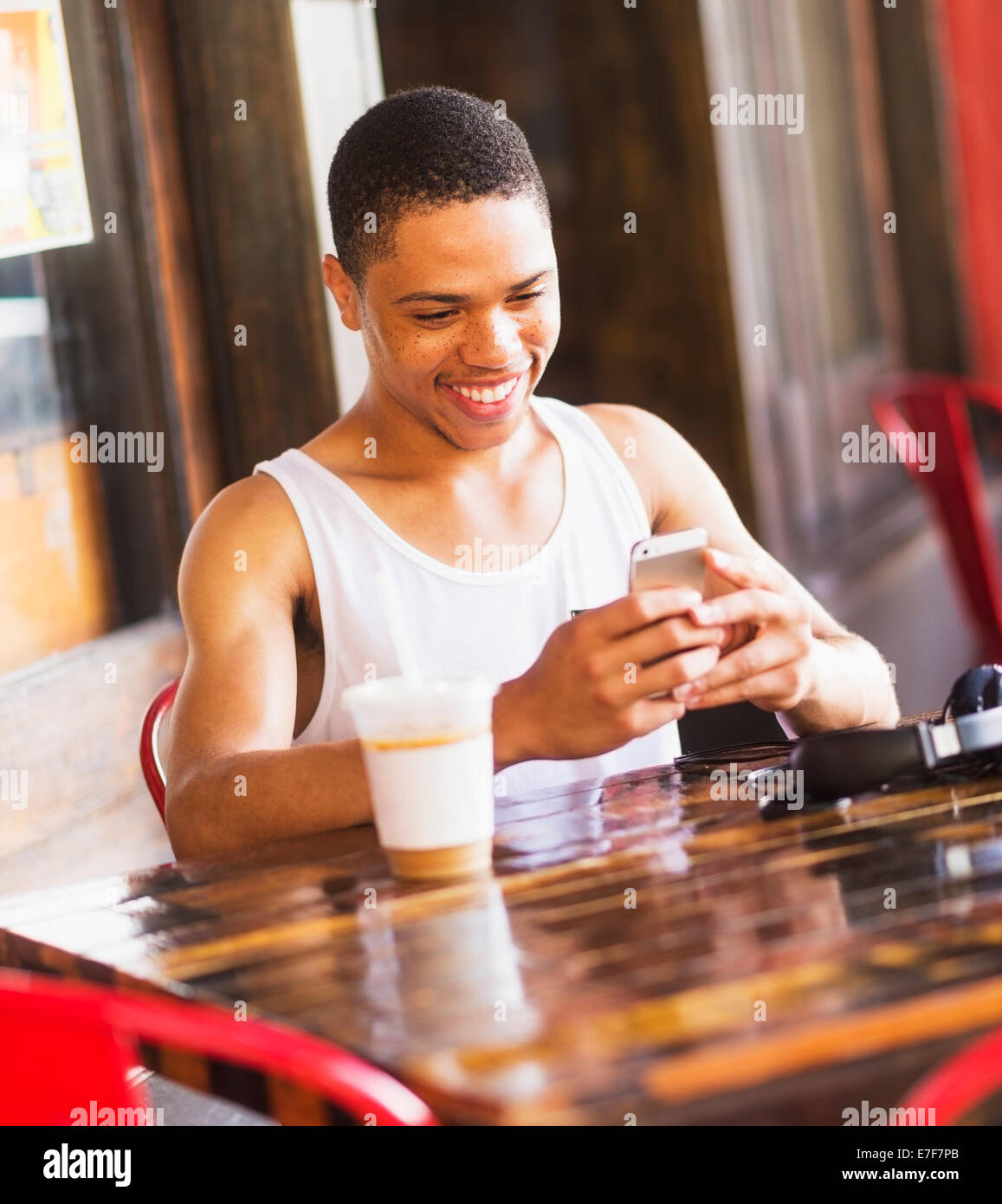 African American man using cell phone at cafe Stock Photo - Alamy