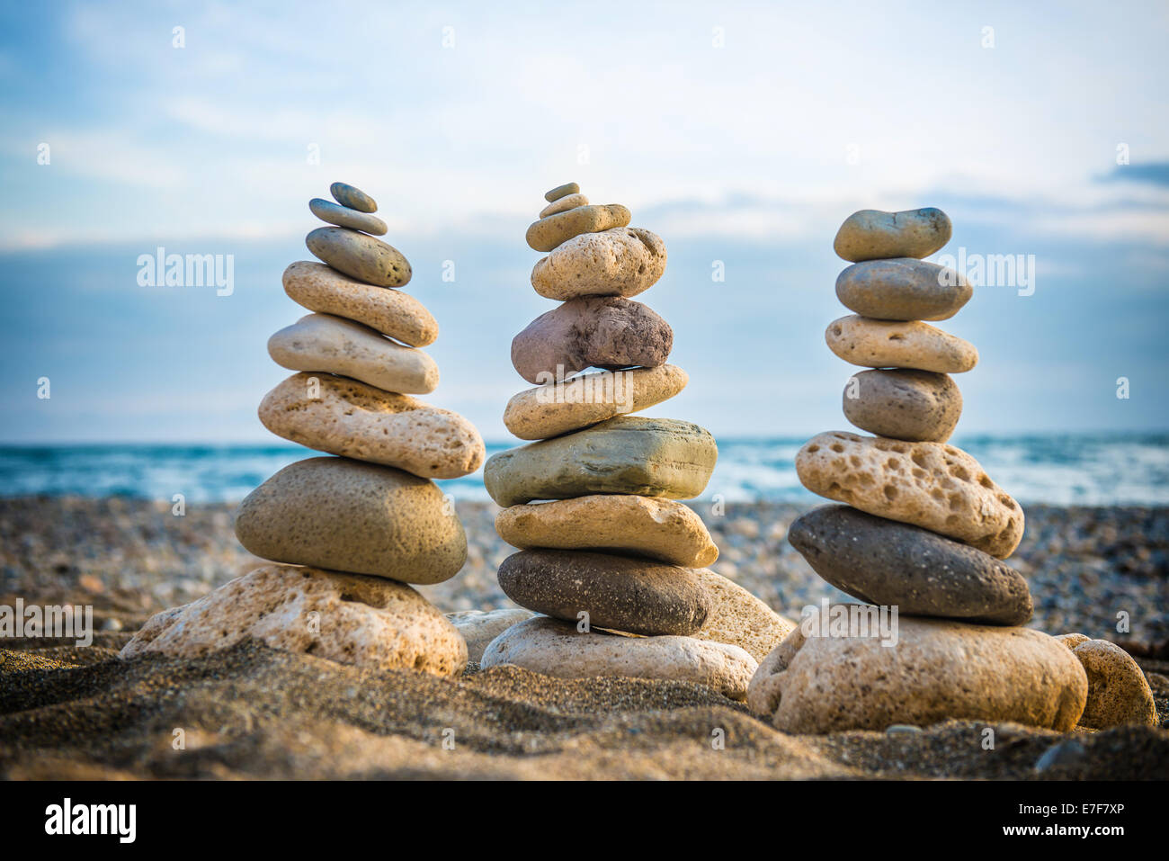Three stacks of round smooth stones on the beach Stock Photo - Alamy